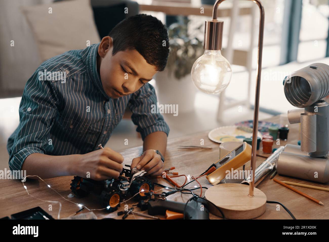 Education, car robot and child in home with homework, homeschool and ...