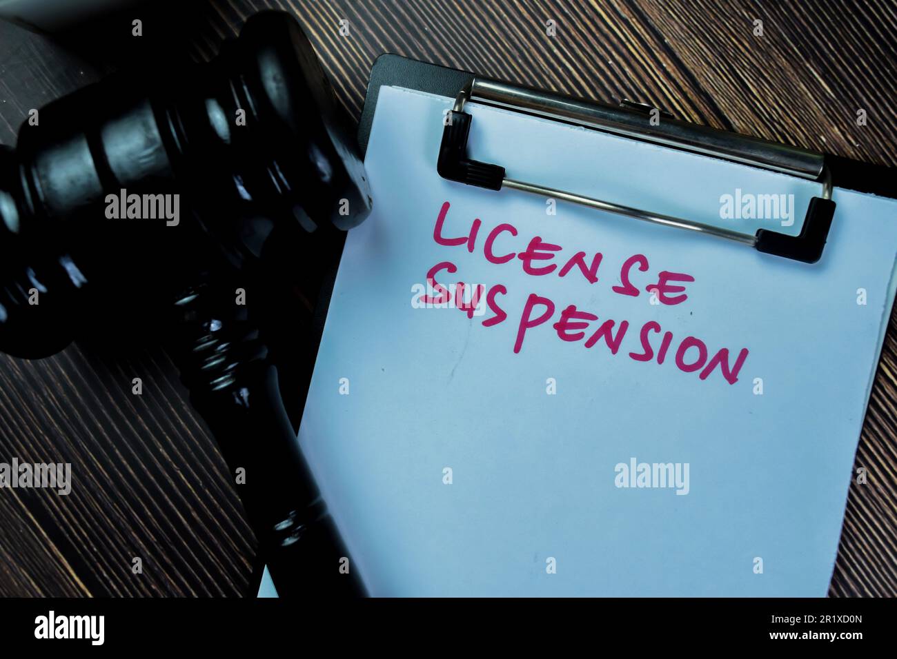 Concept of License Suspension write on paperwork with gavel isolated on Wooden Table Stock Photo ...