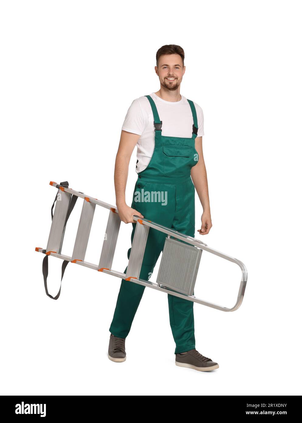 Worker in uniform holding metal ladder on white background Stock Photo ...