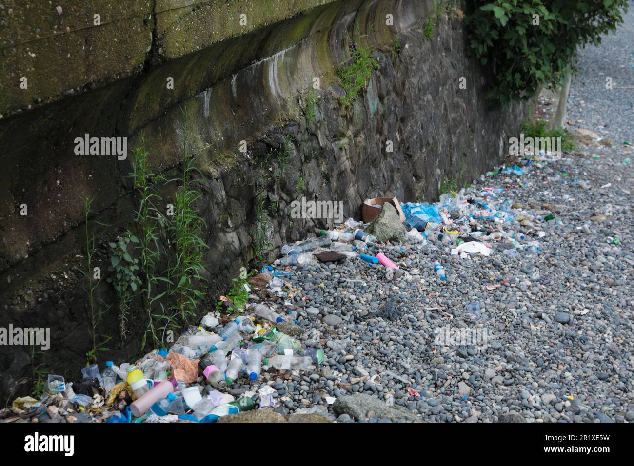 Garbage scattered on pebbles outdoors. Recycling problem Stock Photo ...