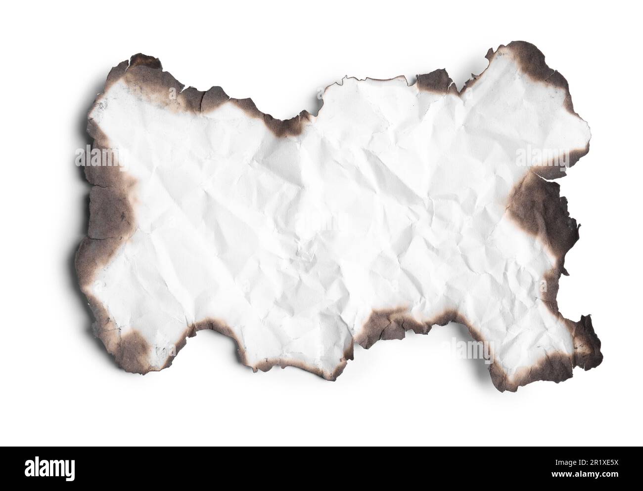 Piece of crumpled paper with dark burnt borders on white background ...
