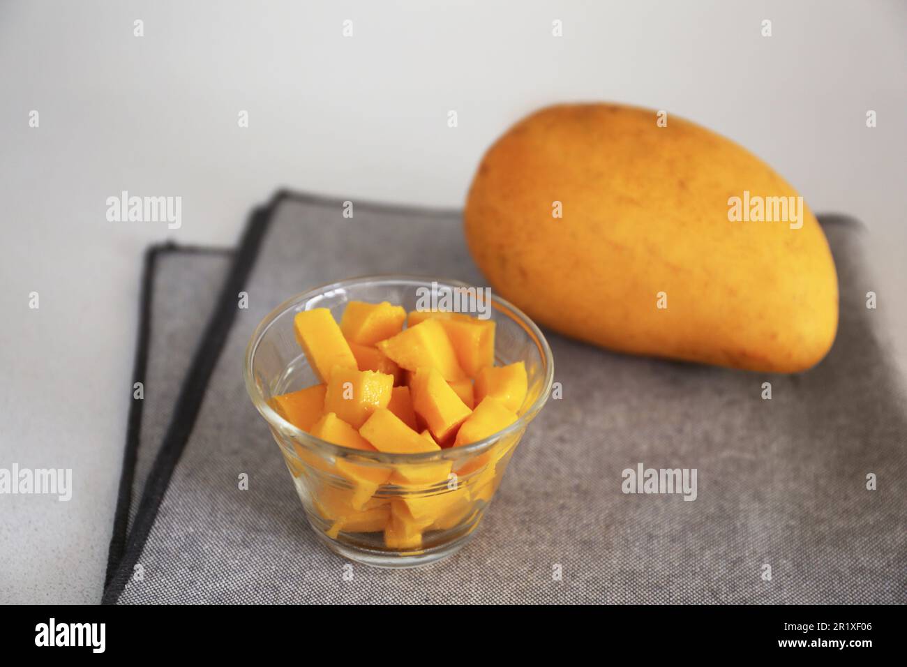 Delicious cut and whole mangoes on light table Stock Photo - Alamy