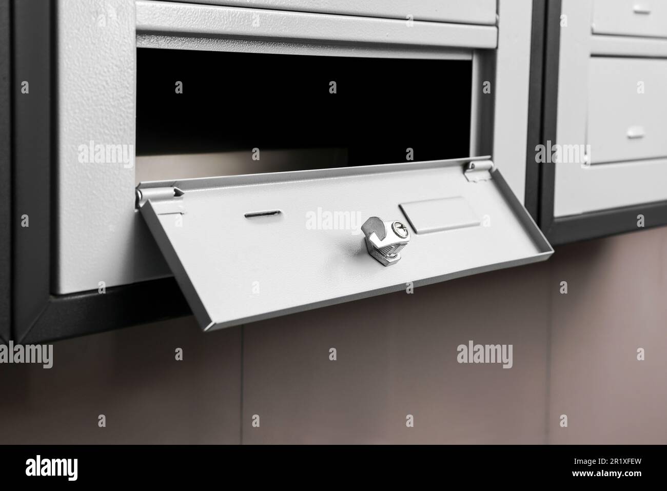 Open empty metal mailbox with keyhole indoors Stock Photo - Alamy