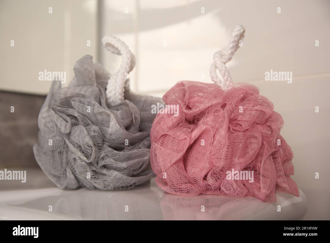 Colorful shower puffs on sink in bathroom, closeup Stock Photo - Alamy
