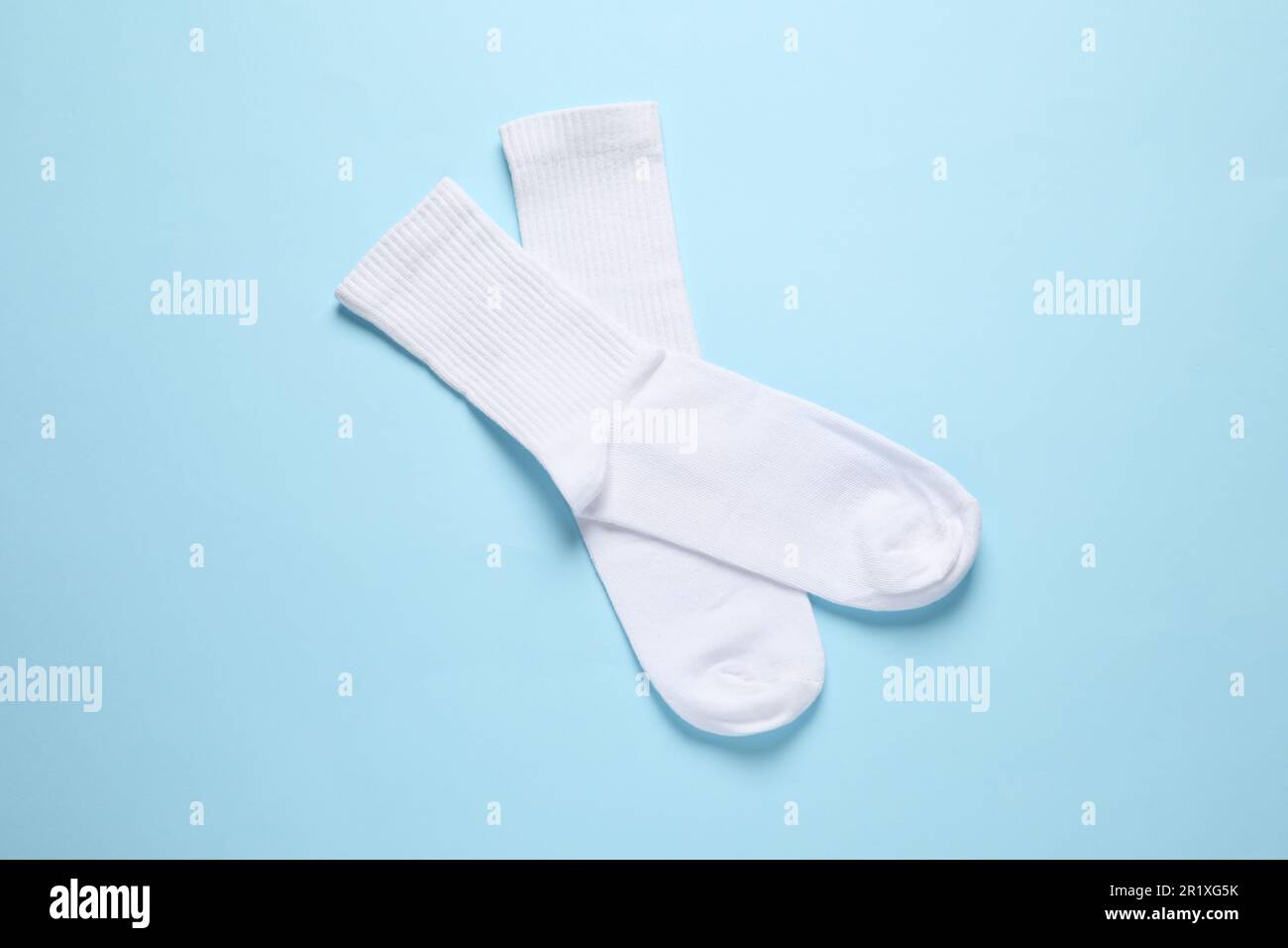 Pair of white socks on light blue background, flat lay Stock Photo - Alamy
