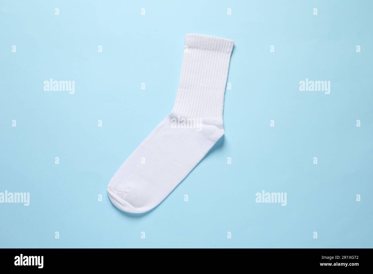 One white sock on light blue background, top view Stock Photo - Alamy
