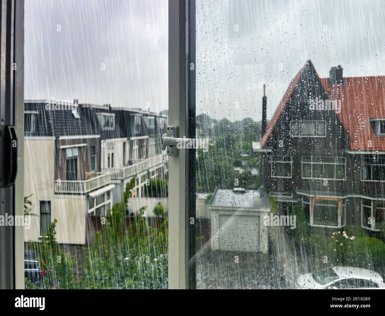 Beautiful cityscape with buildings on rainy day, view through open ...