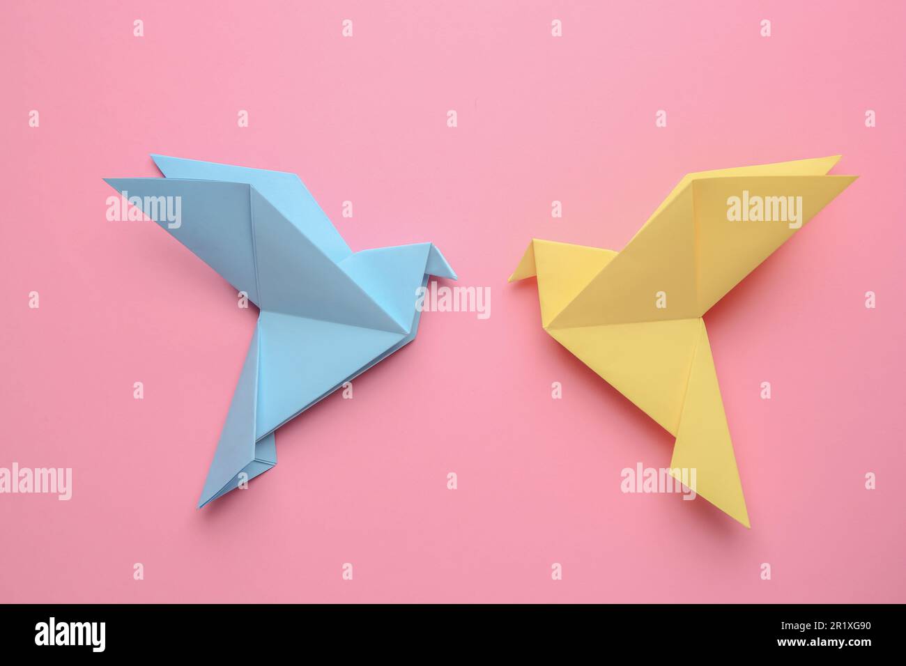 Beautiful colorful origami birds on pink background, flat lay Stock ...