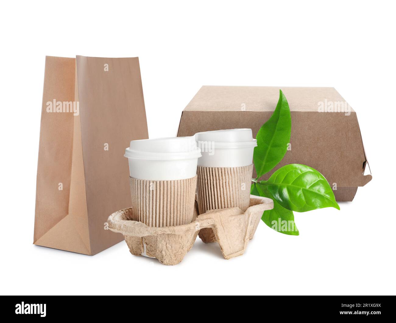 Different containers, coffee cups and green fresh leaves on white ...