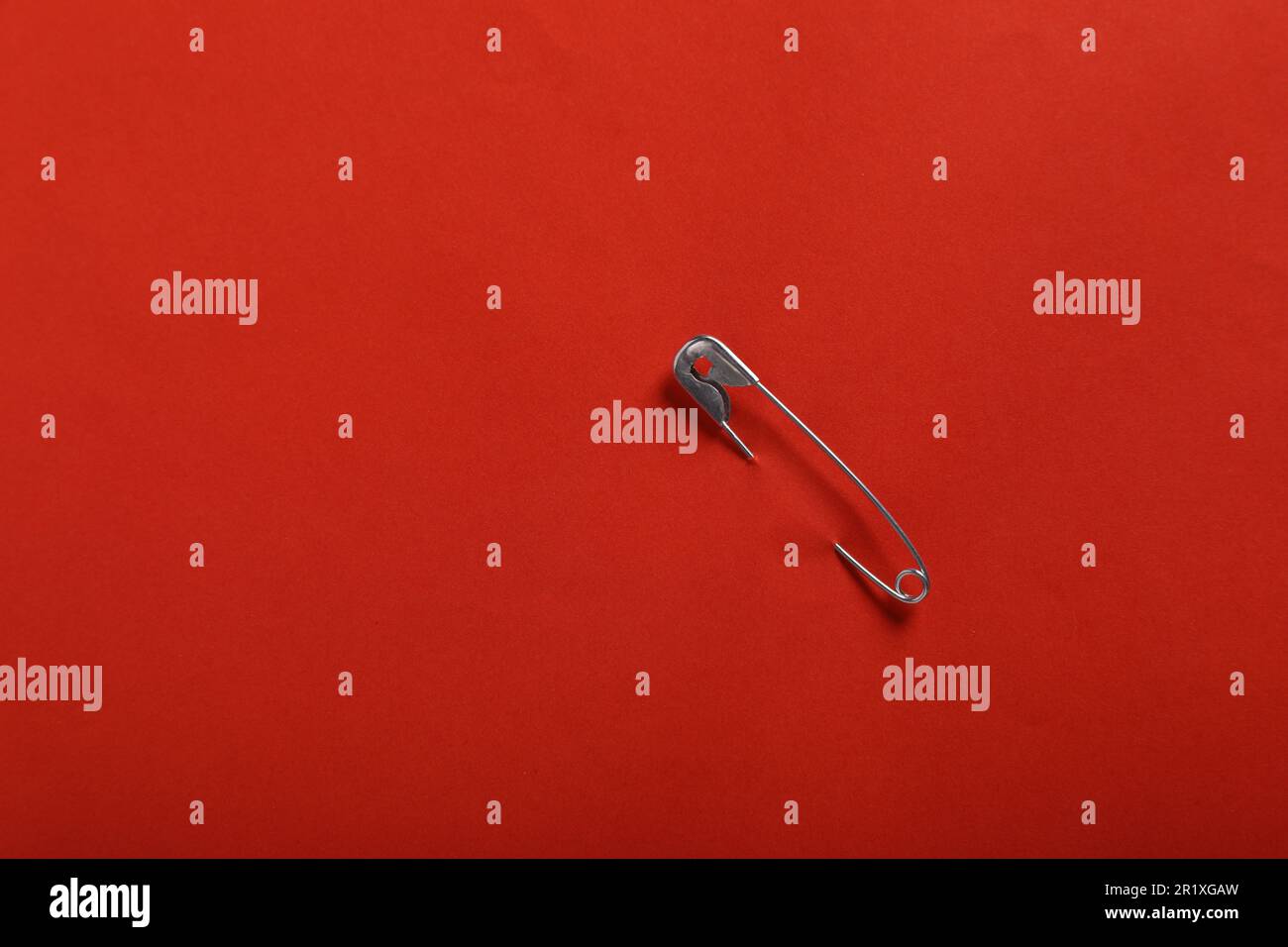 Safety pin attached on red paper, top view. Space for text Stock Photo ...