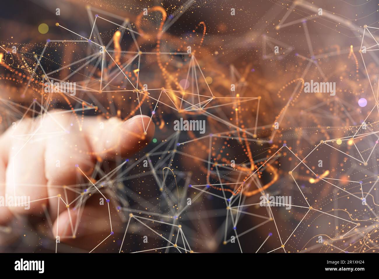 A close-up shot of a human hand pointing at a complex web of ...