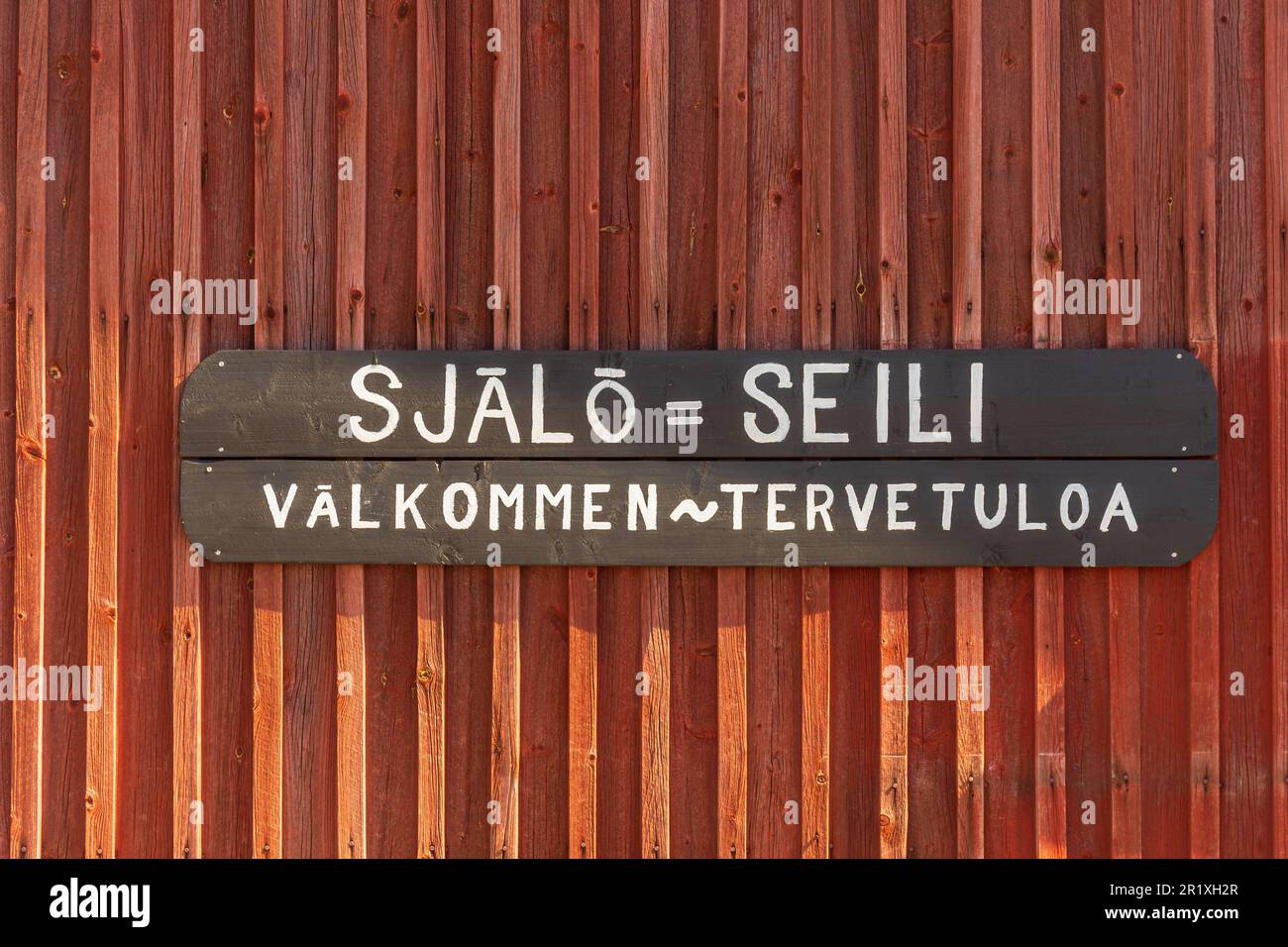 Själö - Seili Tervetuloa sign on red pained wall at the harbour of ...