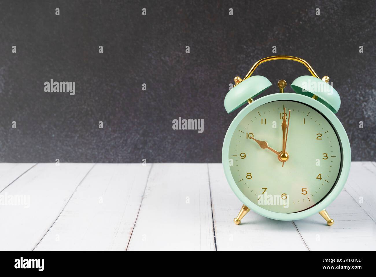 vintage retro alarm clock ten time o'clock on table wood with dark ...