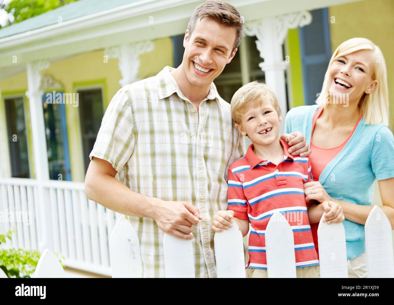 Theyre the perfect young family. Happy young family standing together ...