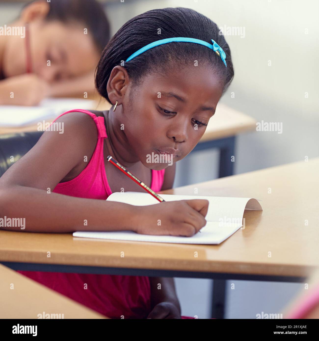 Learning something new every day. a cute little girl doing her work in ...