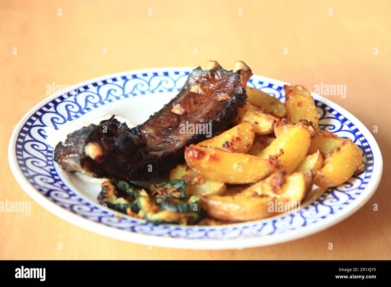 grilled ribs and potatoes as very nice food background Stock Photo - Alamy