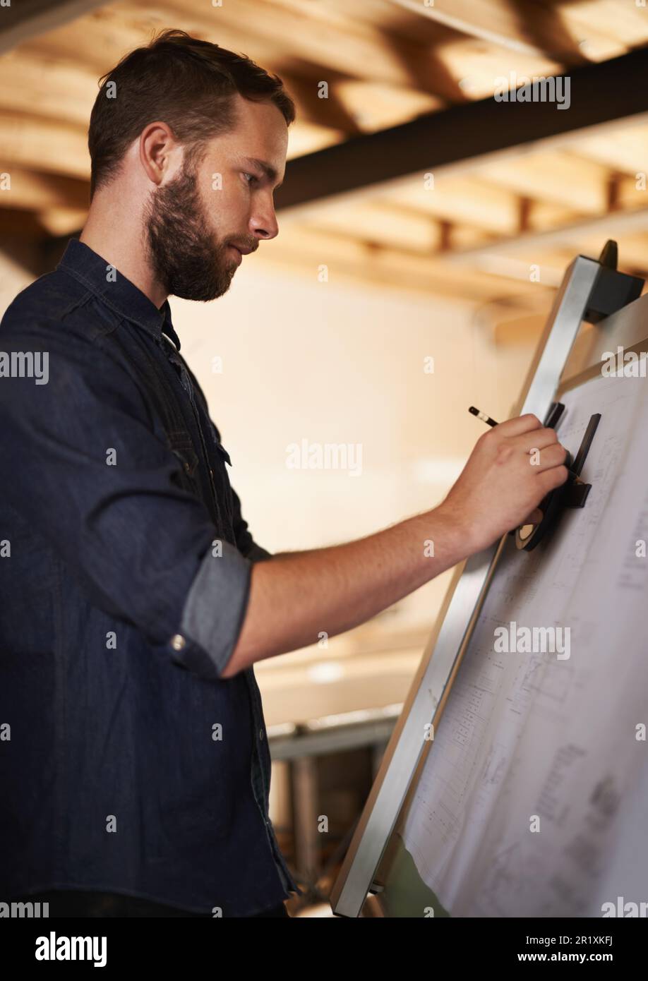 Turning his vision into reality. An architect drawing up plans Stock ...