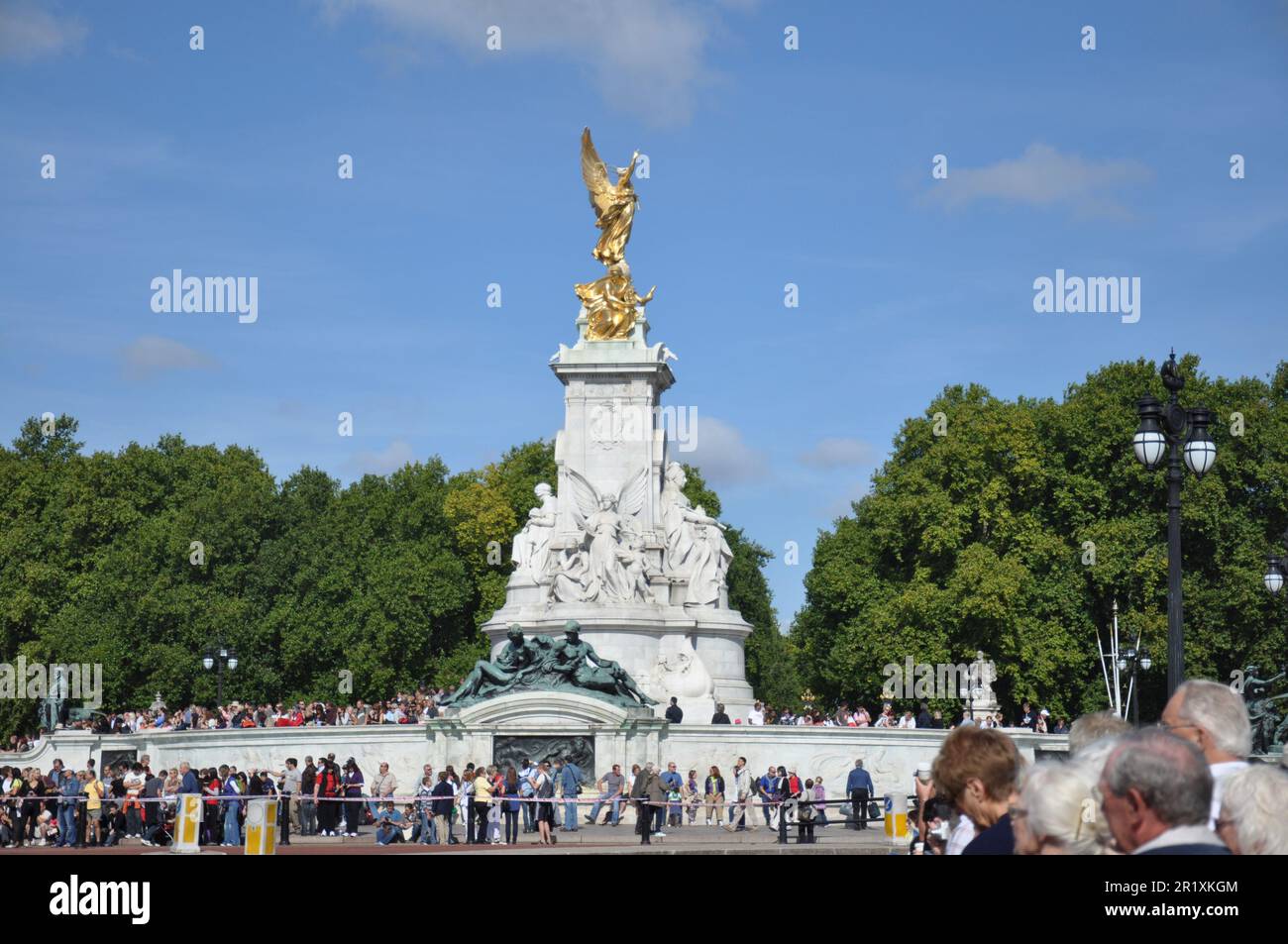 A large crowd of people gathered in front of the iconic Queen Victoria ...