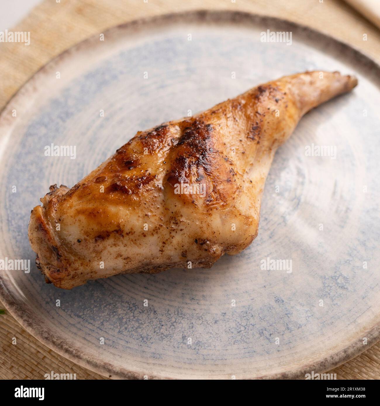 Oven roasted rabbit leg Stock Photo - Alamy