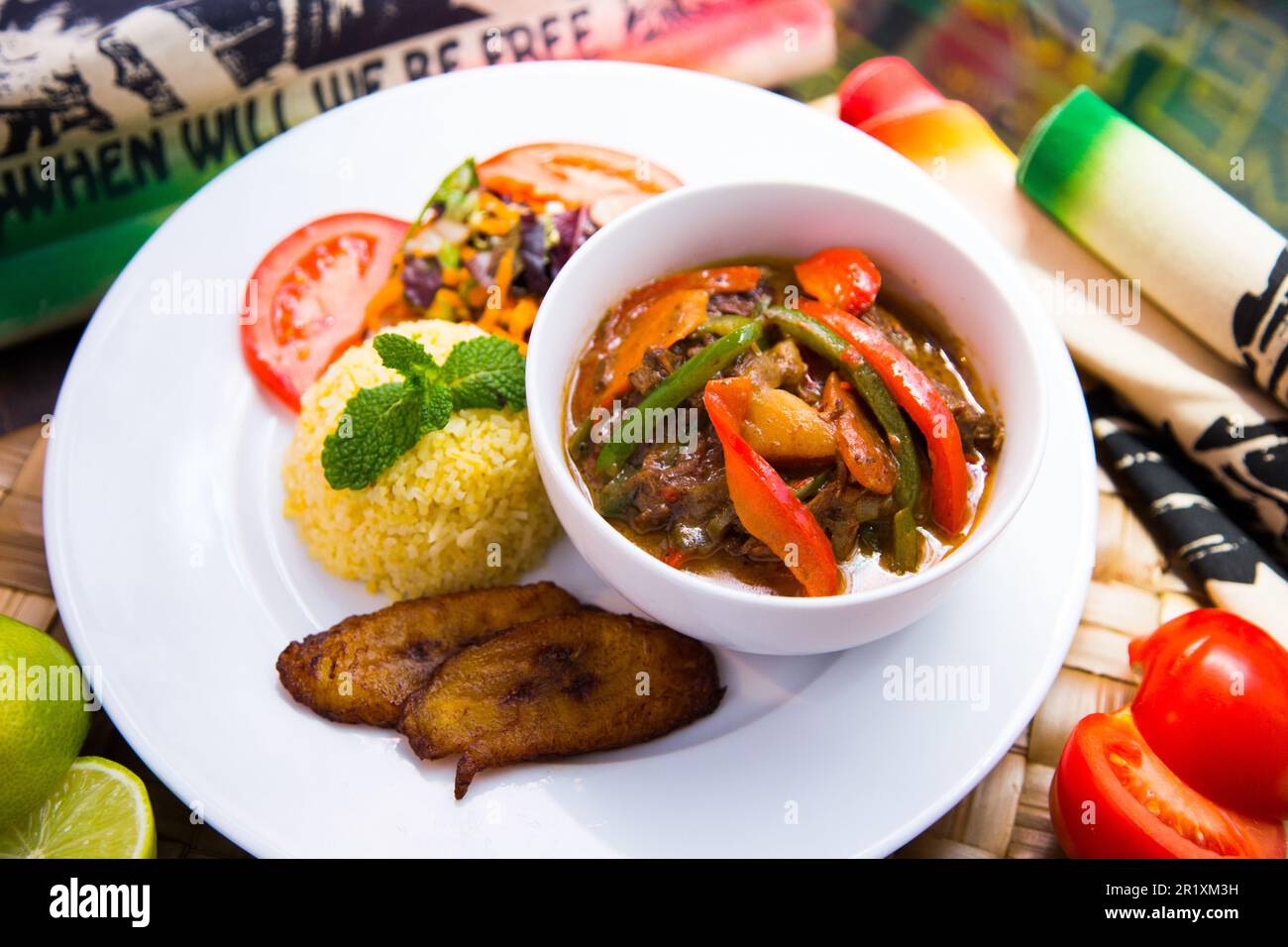 Jamaican vegetable dish served with rice and banana Stock Photo - Alamy