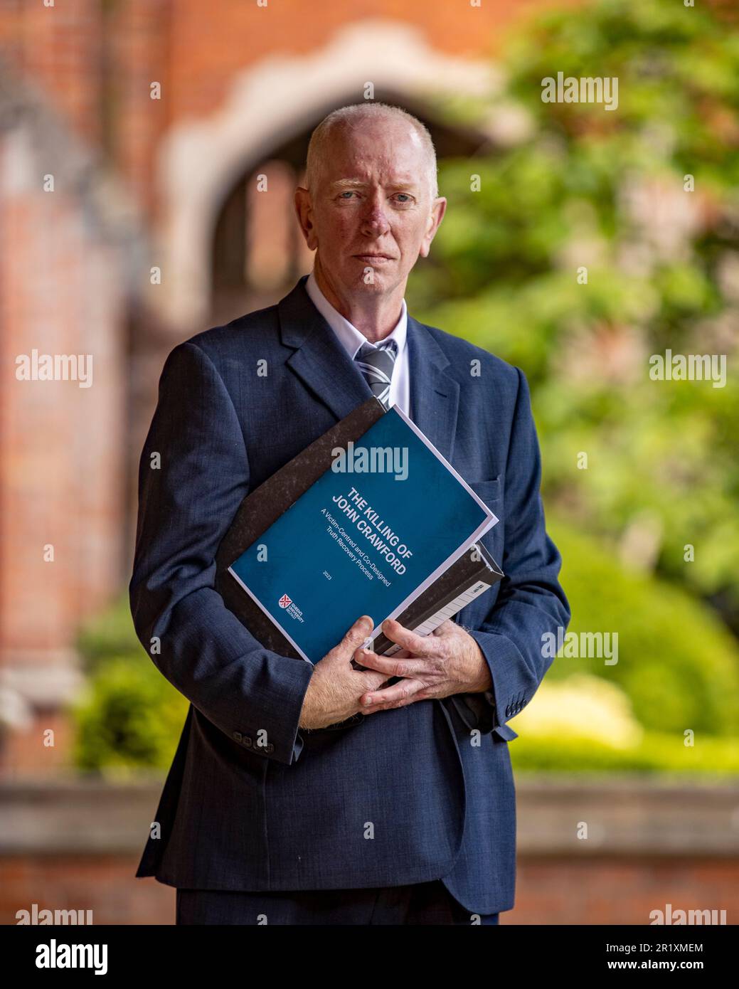 Paul Crawford, at Queens University Belfast, holds a copy of a report by Queens University ...