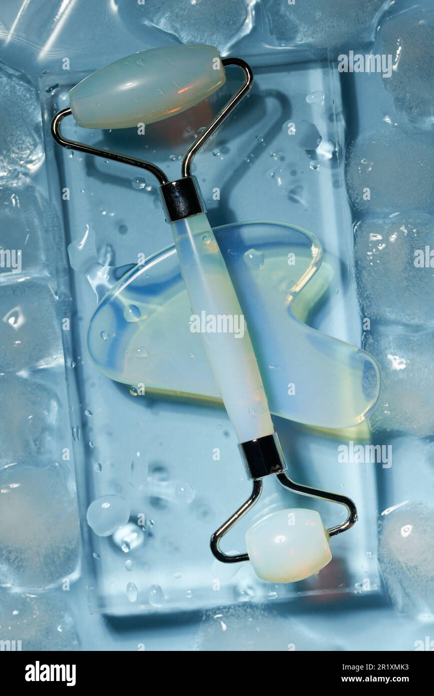 Blue jade face roller and Gua Sha scraping for beauty facial massage ...