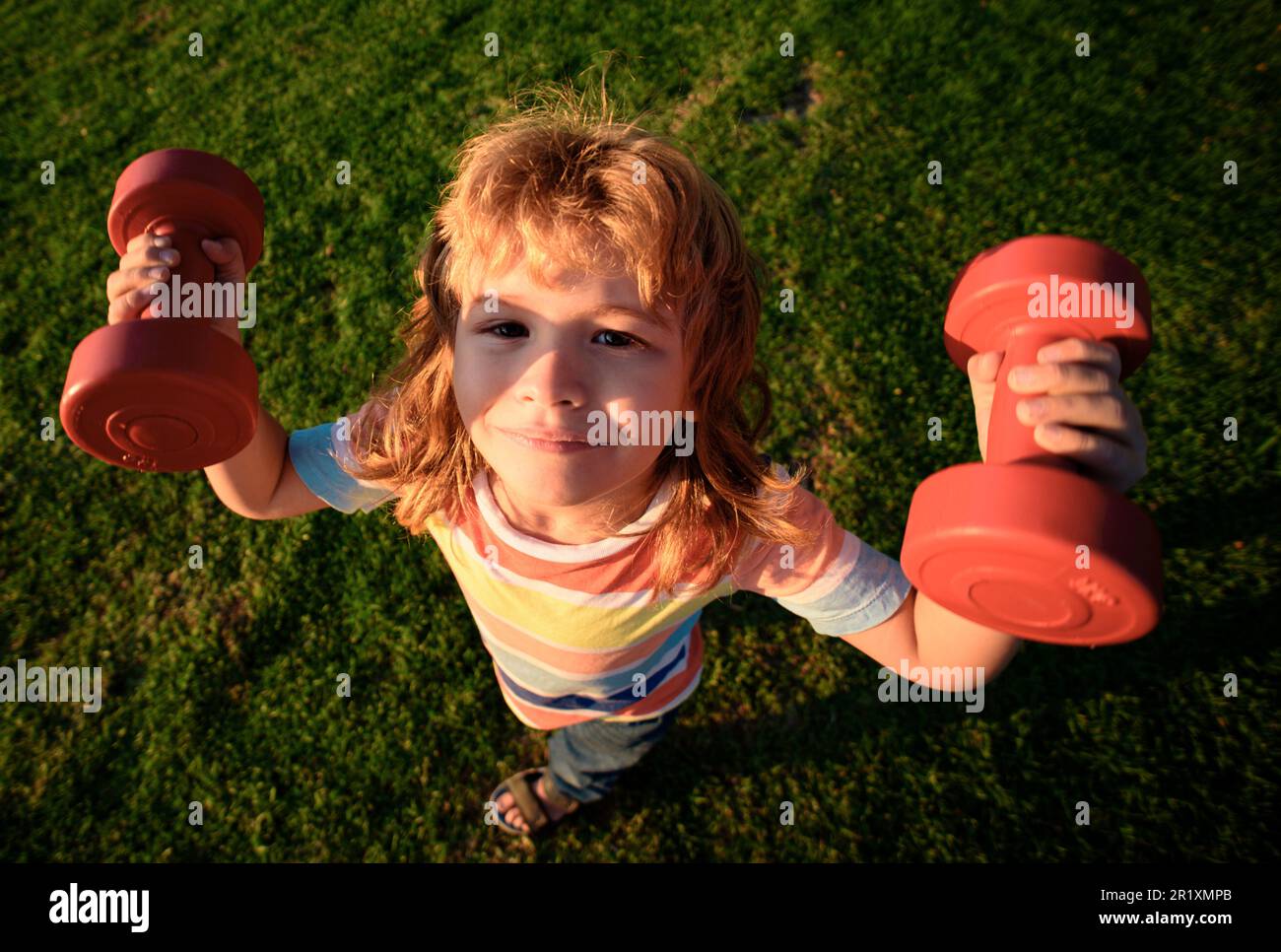 Strong little boy. Funny child face. Sports for development and healthy ...