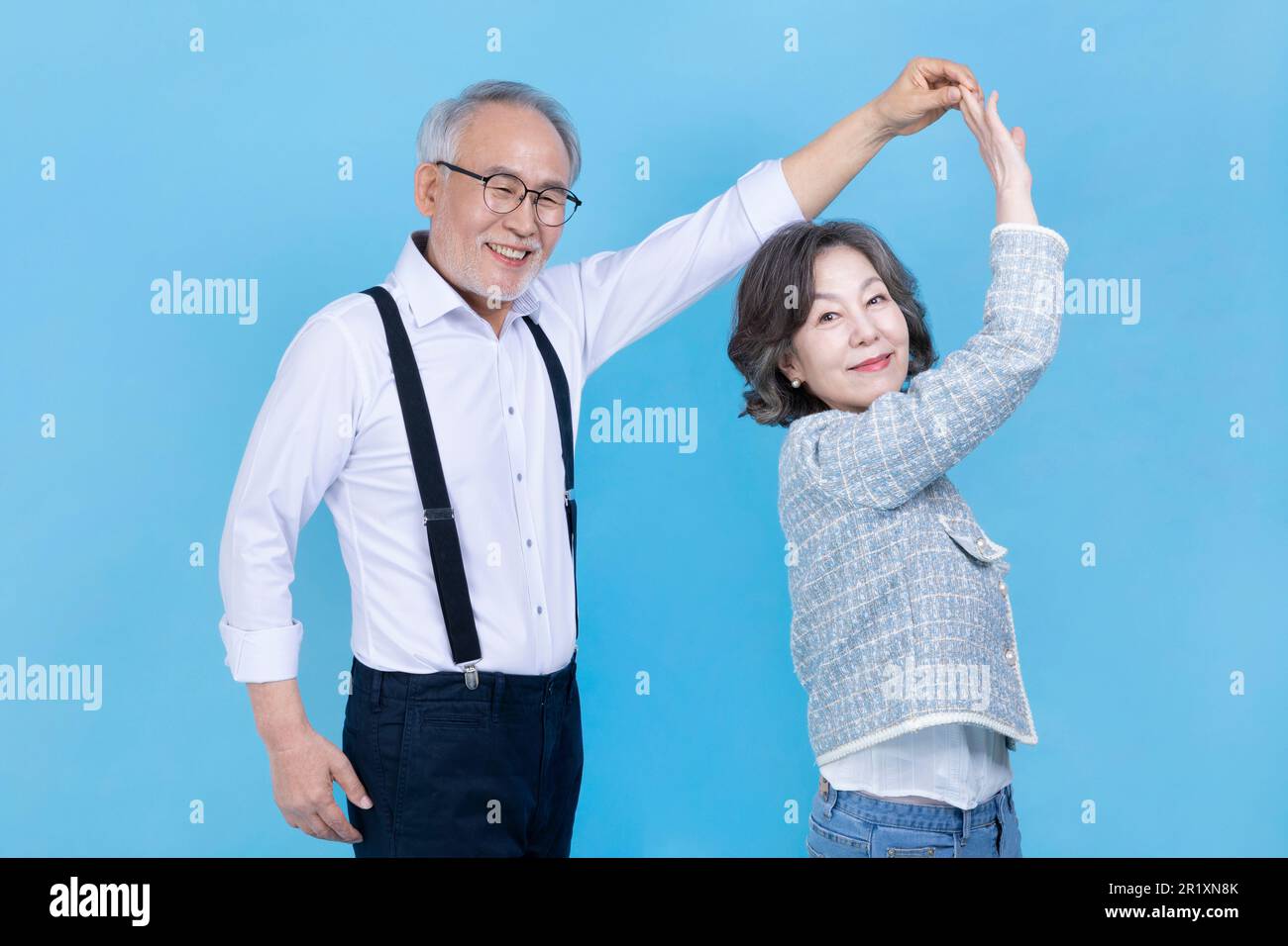 dancing active young senior Korean Asian couple, studio background ...