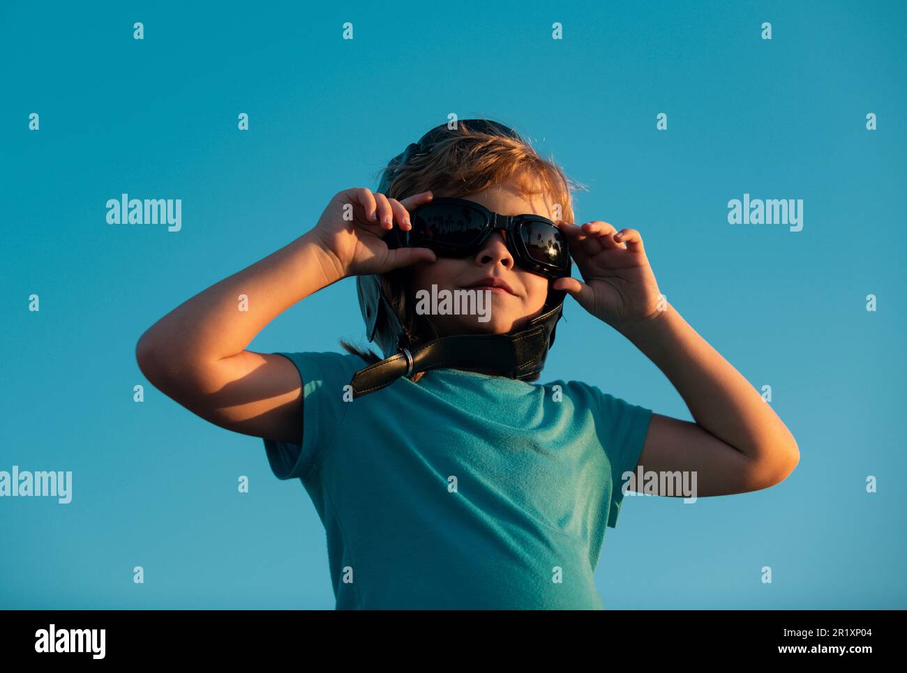 Little boy with pilot goggles and helmet, boy wants to become pilot and ...