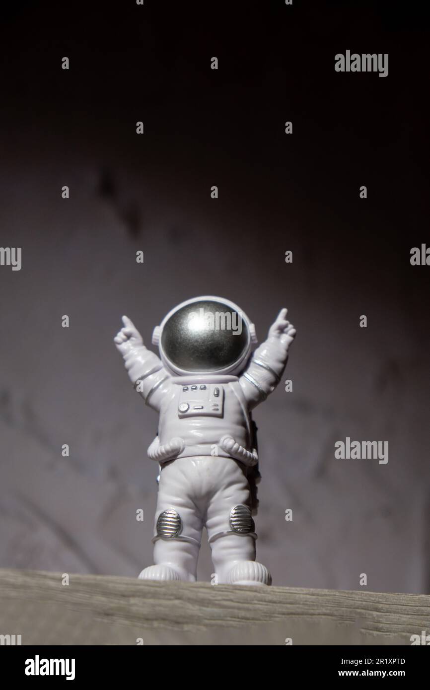 Plastic toy figure astronaut on moon concrete background Copy space ...