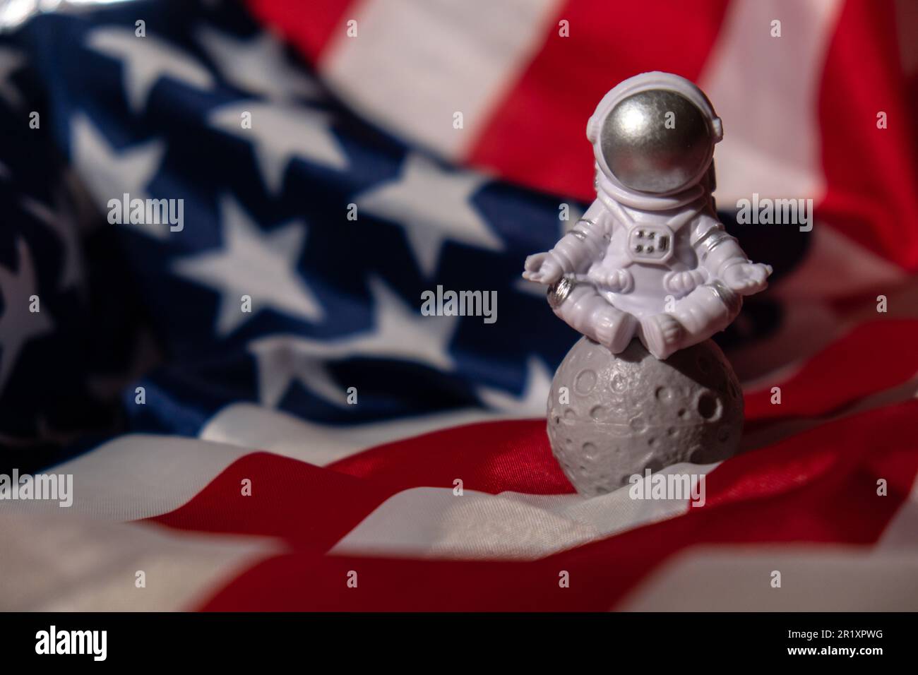 Plastic toy figure astronaut on American flag background Copy space ...