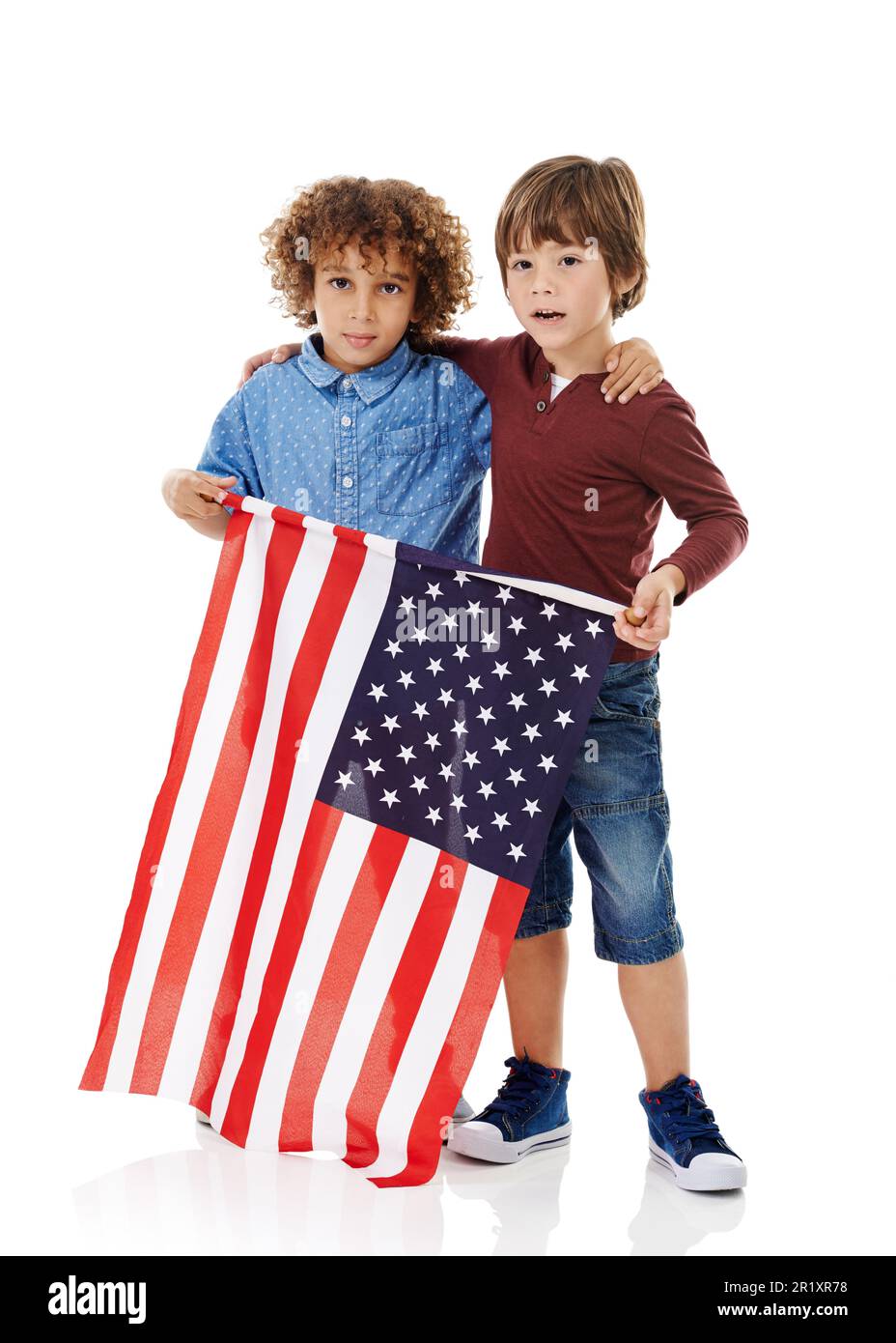 Pals in patriotism. Studio shot of two cute little boys holding the ...