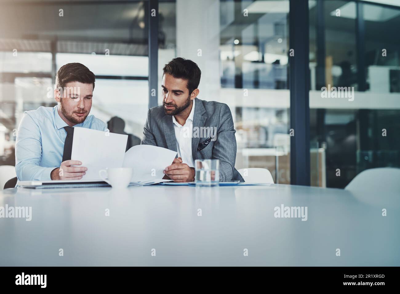 Meeting, documents and businessmen in discussion in the office ...