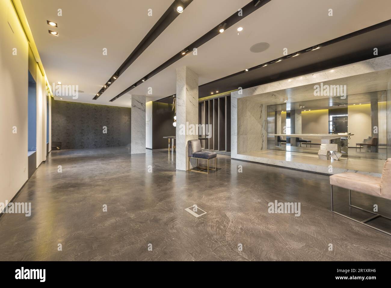 An empty retail space with polished concrete floors and ceiling ...