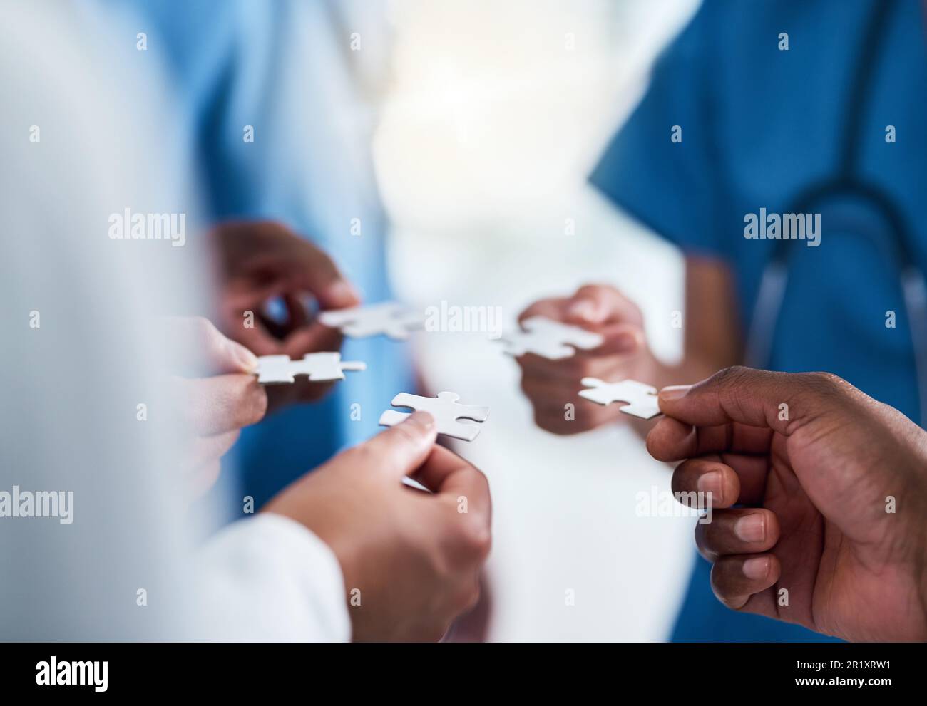 Hands, puzzle and teamwork of doctors in hospital for team building ...