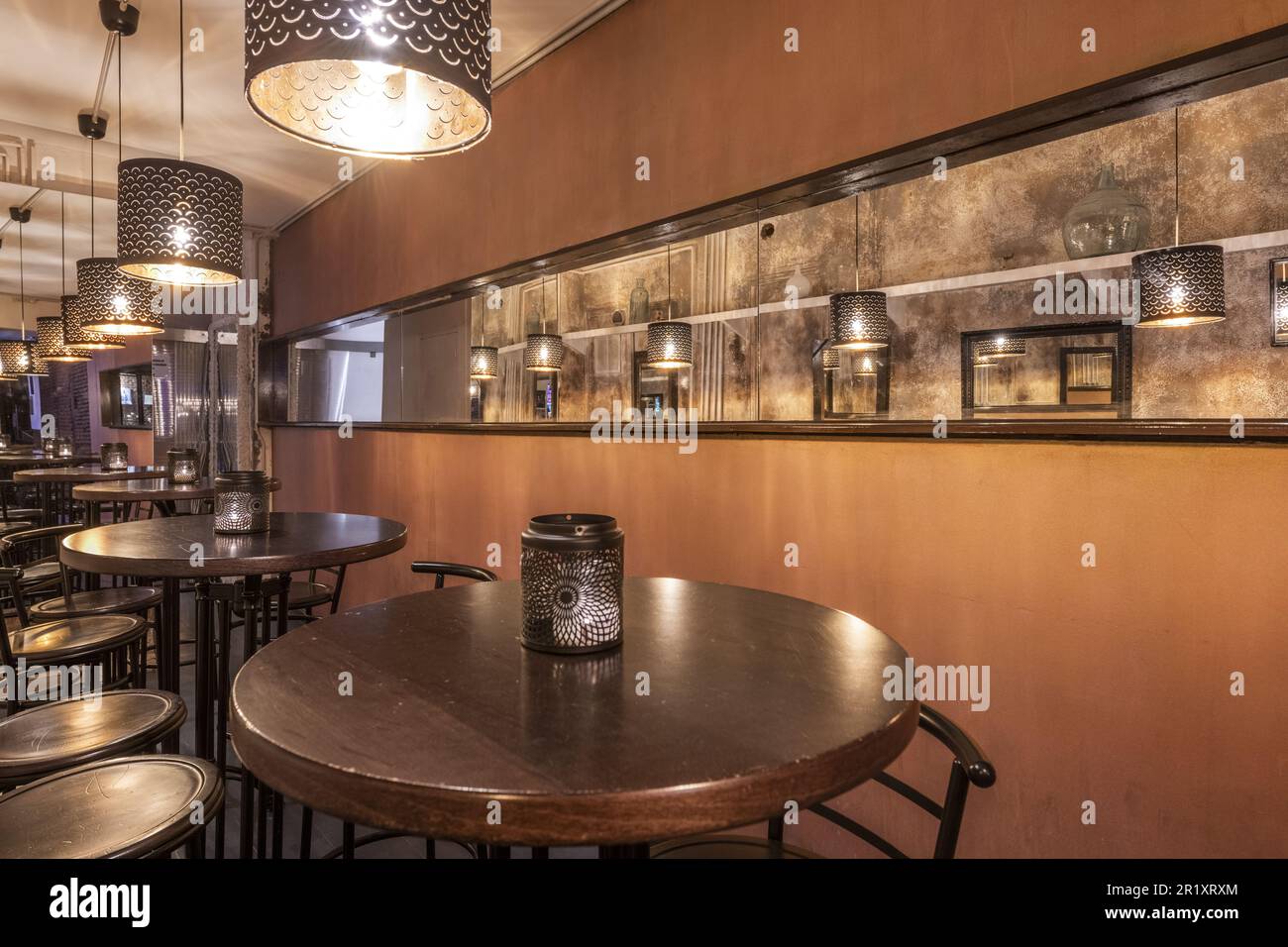 A group of circular high top tables with matching stools in a nightclub ...