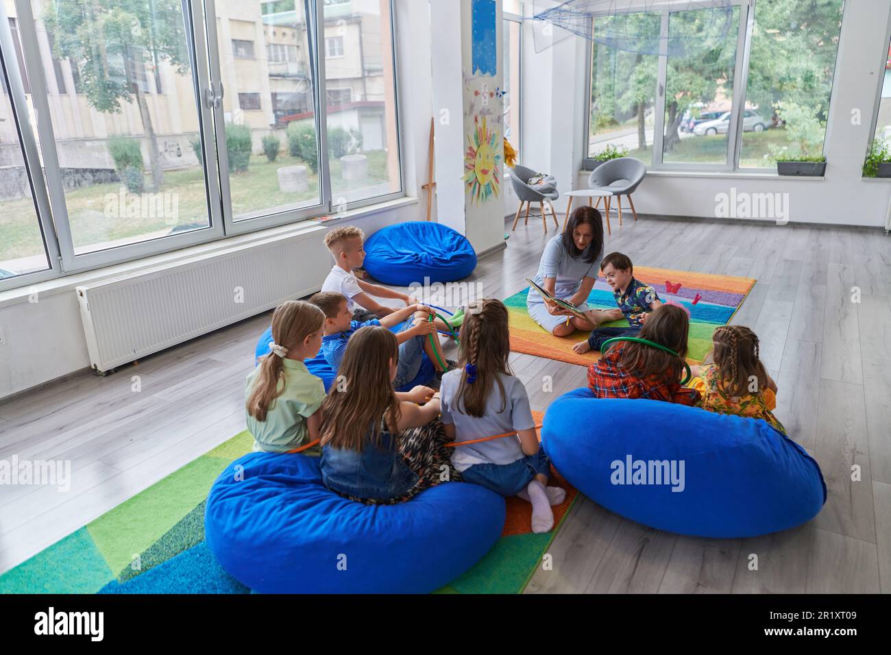 Reading time in an elementary school or kindergarten, a teacher reading ...