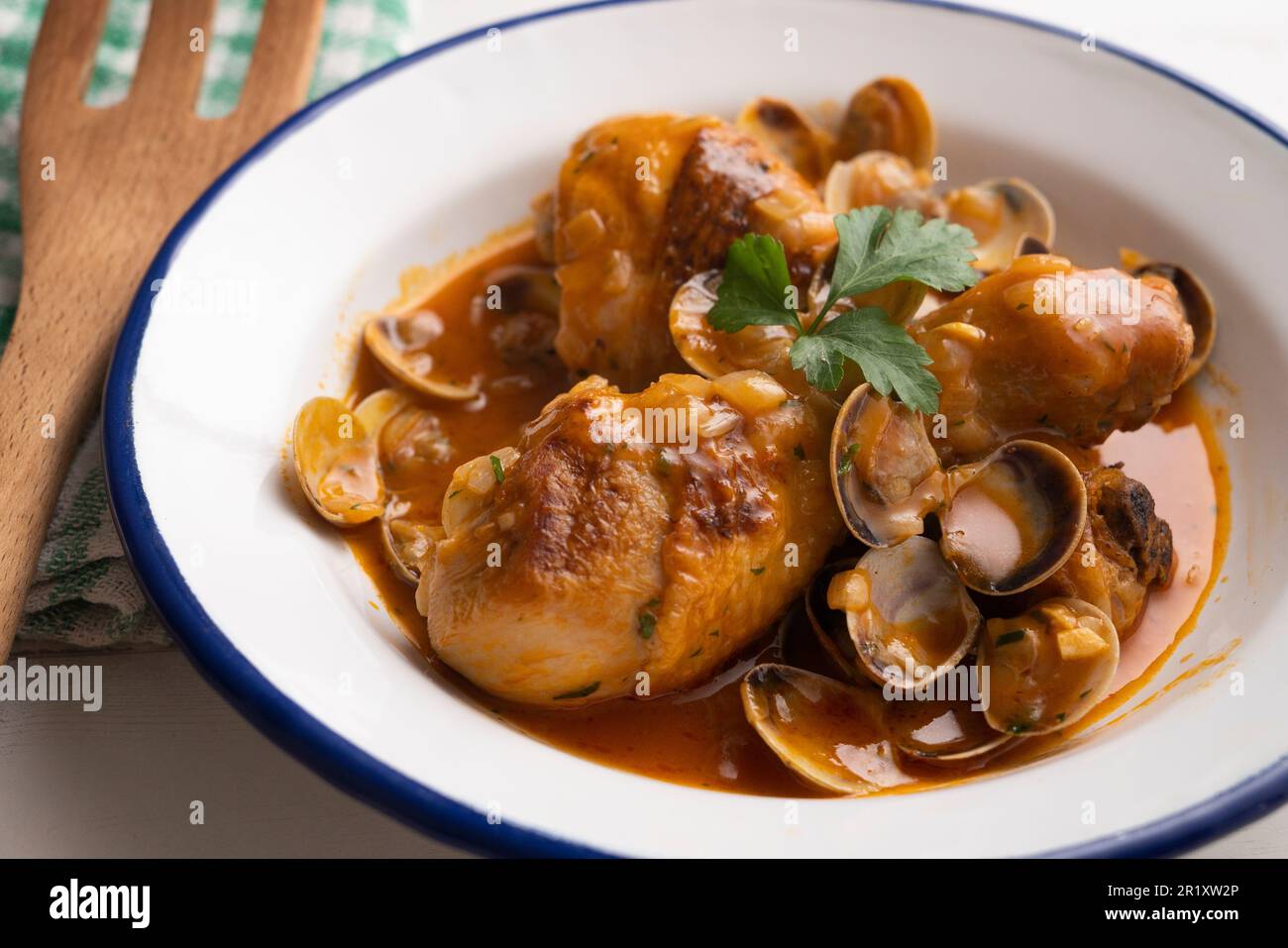 Baked chicken thighs with clams. Traditional Spanish tapa Stock Photo ...