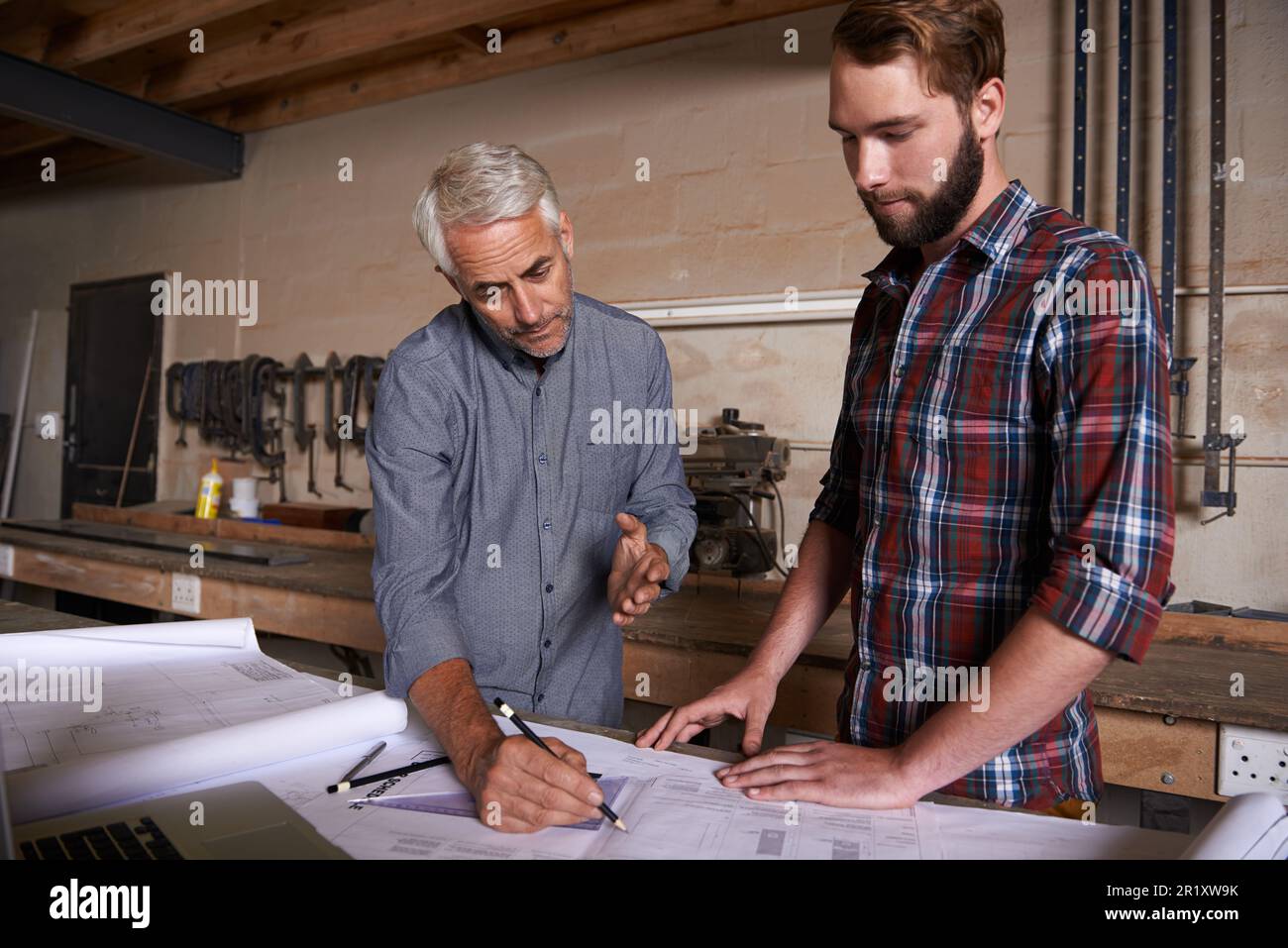 Turning his vision into reality. An architect drawing up plans Stock ...