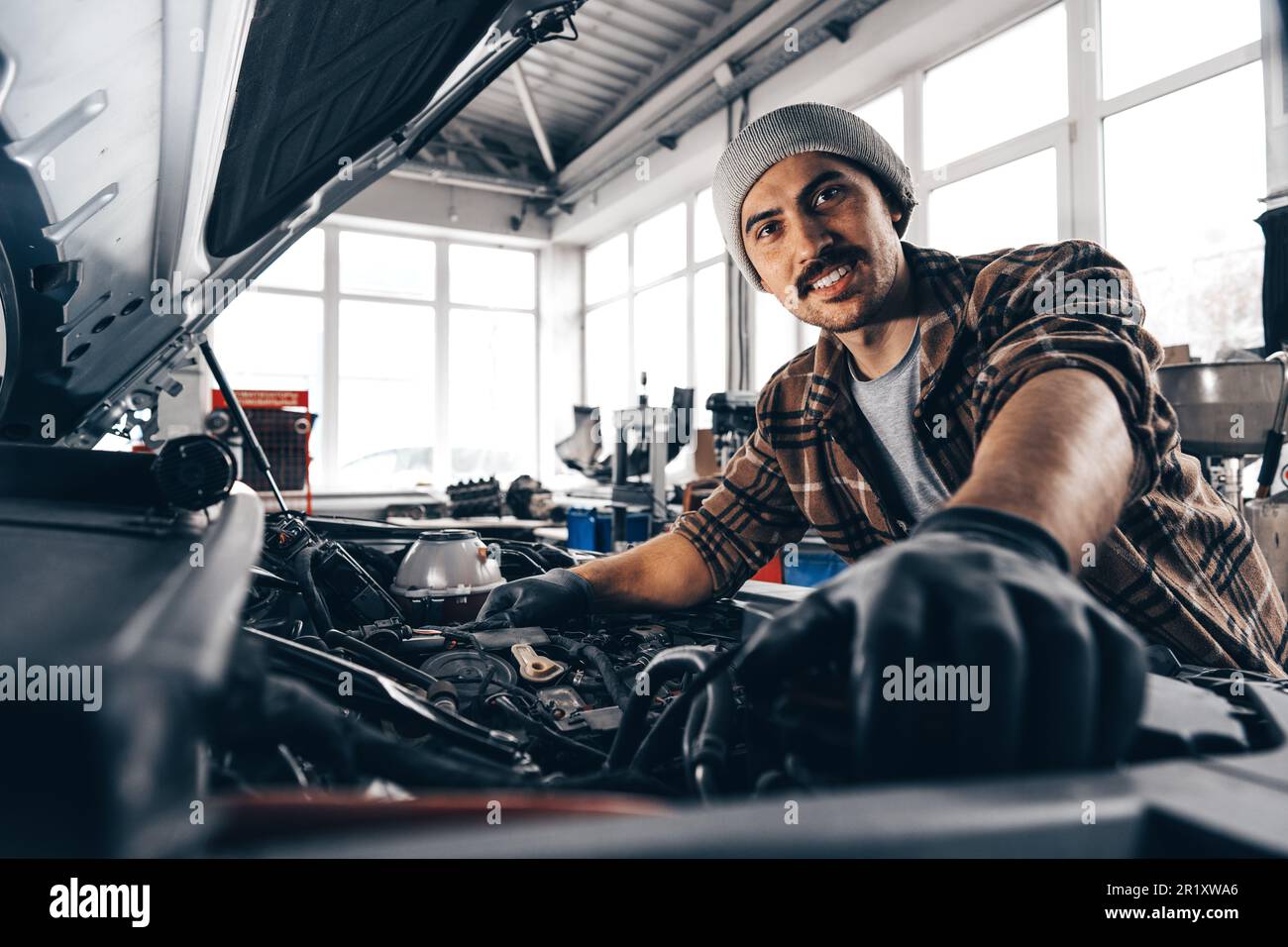Mechanic examining car in auto car repair service center Stock Photo ...