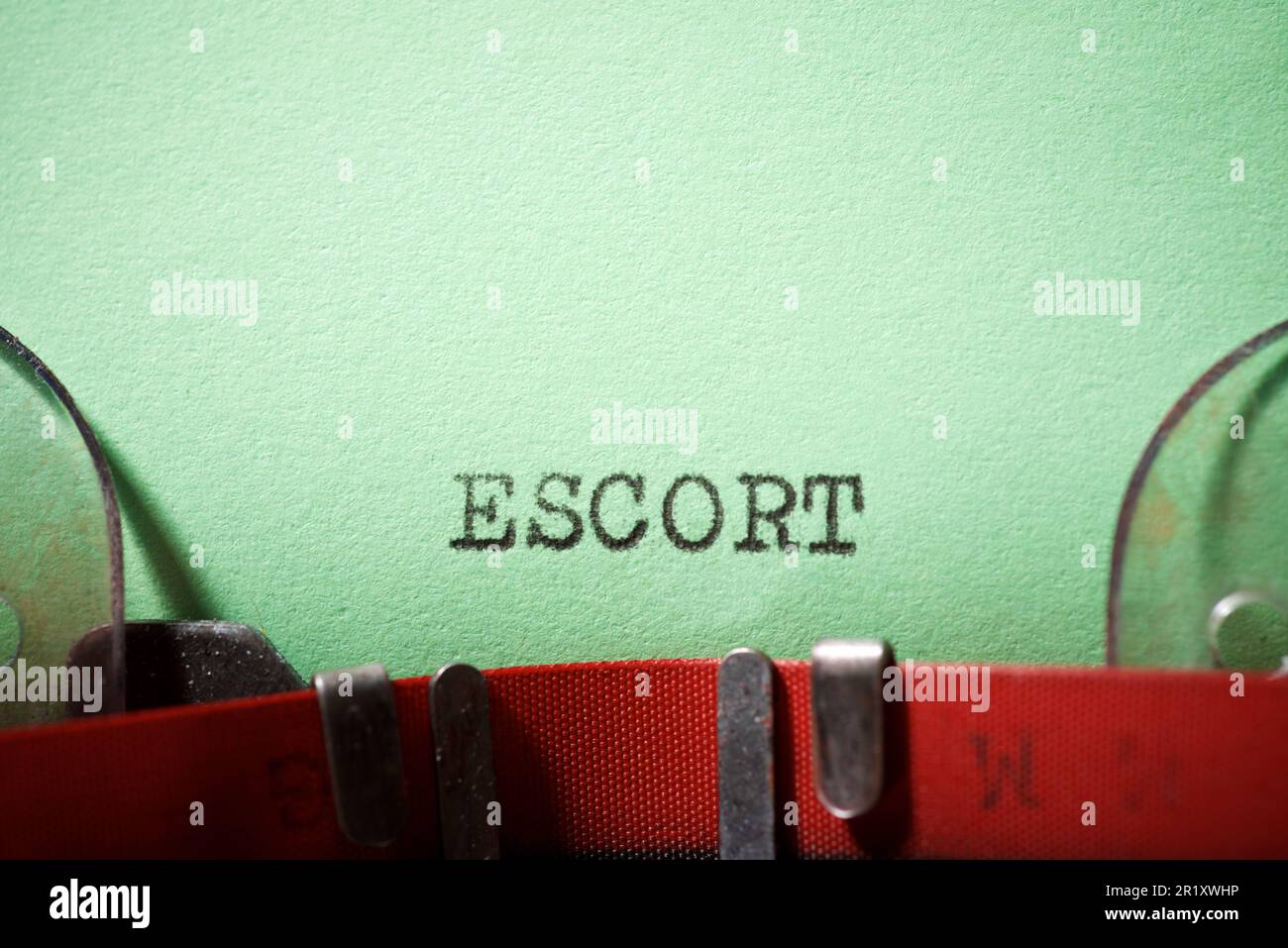 Escort word written with a typewriter Stock Photo - Alamy
