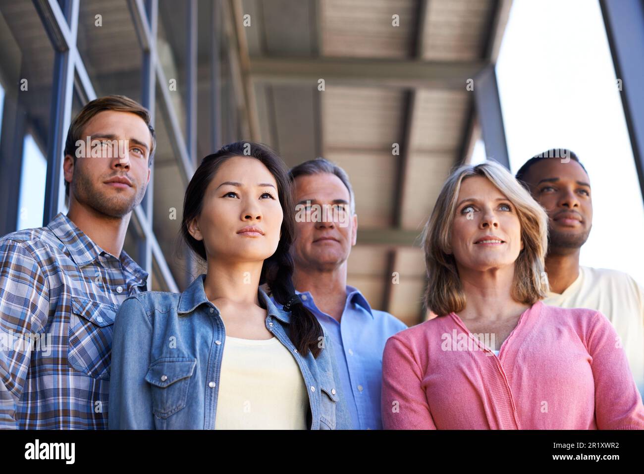 Focussed on success. a diverse group of casually-dressed employees ...