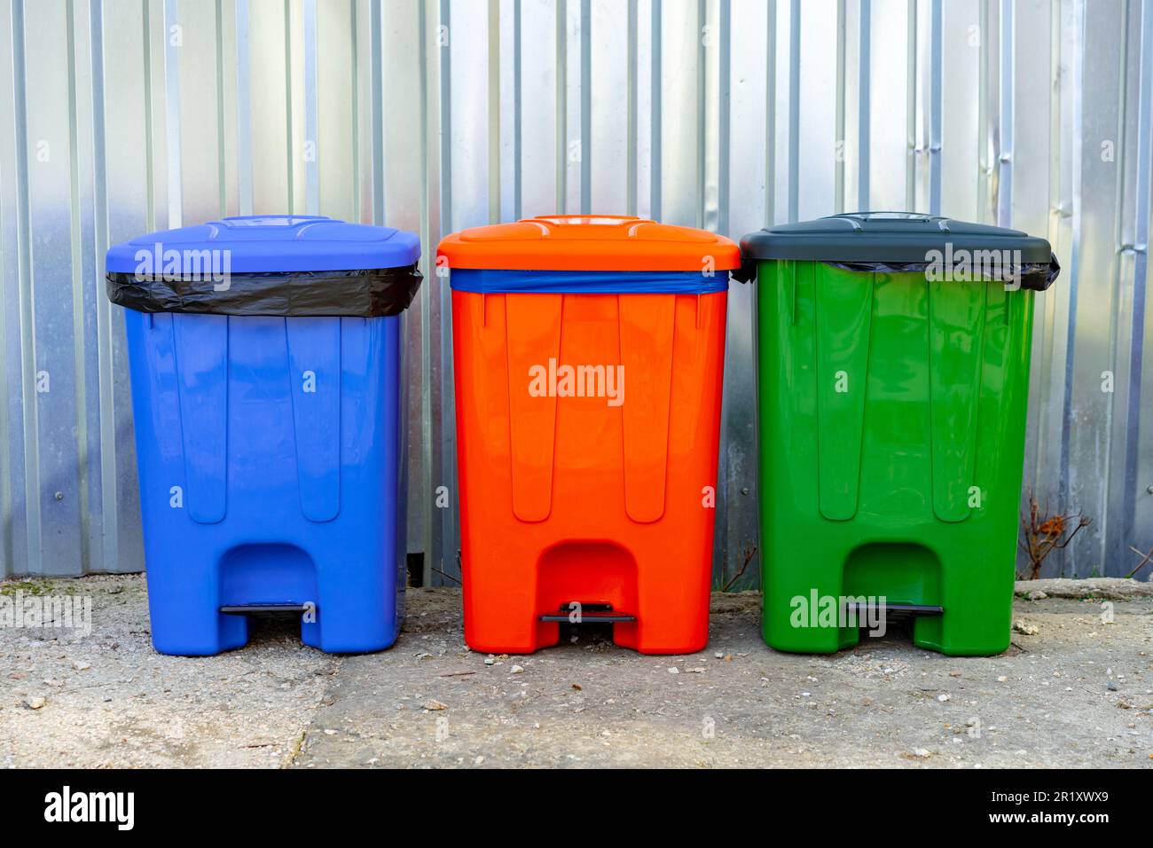 Color garbage bins in the city street on metal background Stock Photo ...