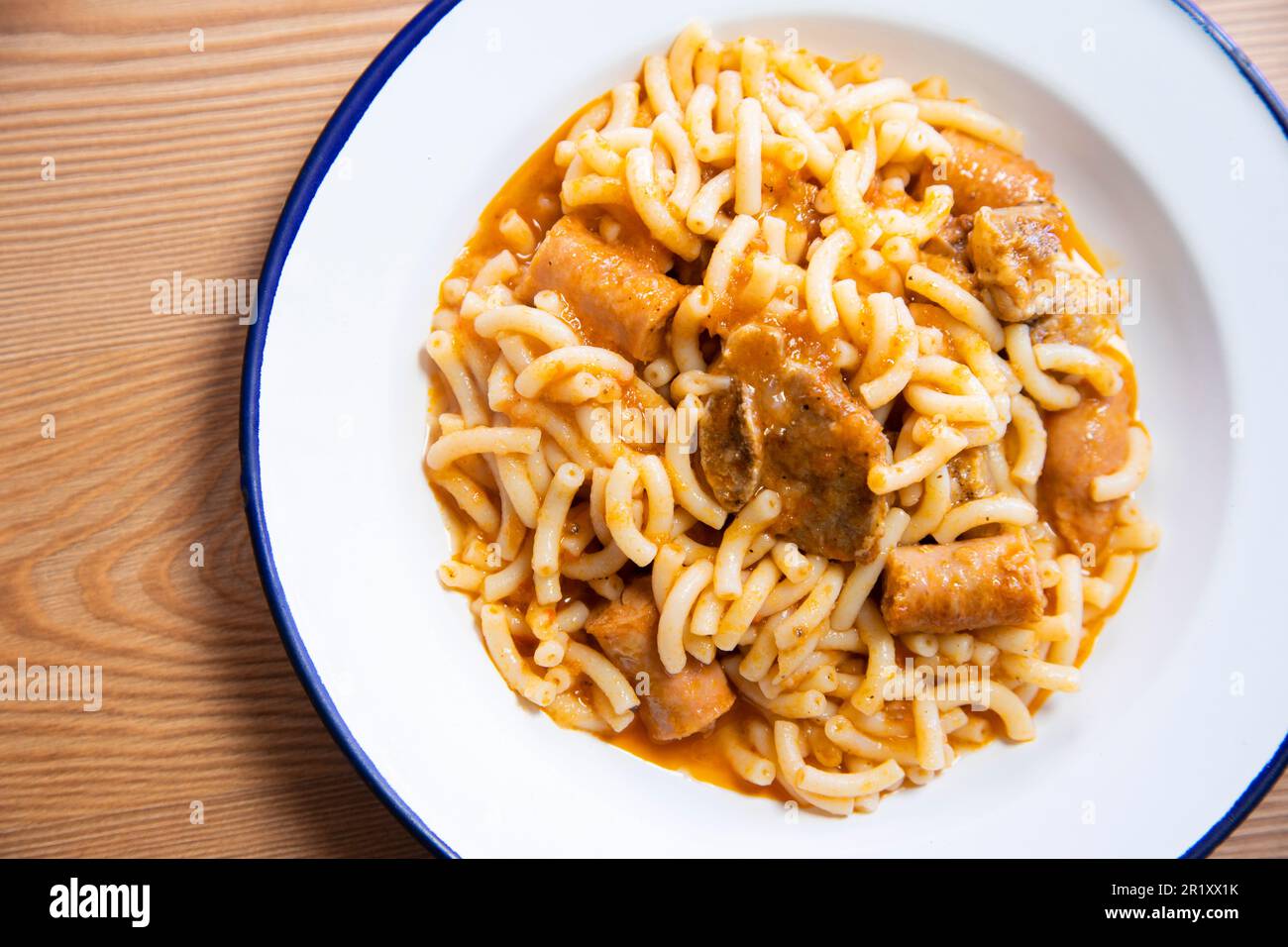 Paella fideua with pork. Fideuá is a dish originally from Gandía that ...