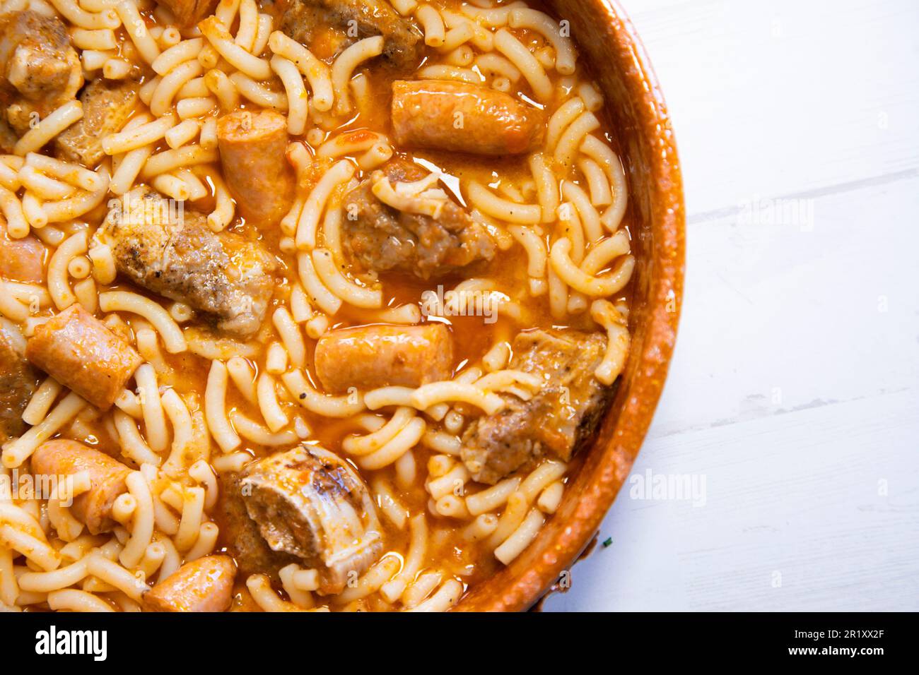 Paella fideua with pork. Fideuá is a dish originally from Gandía that ...