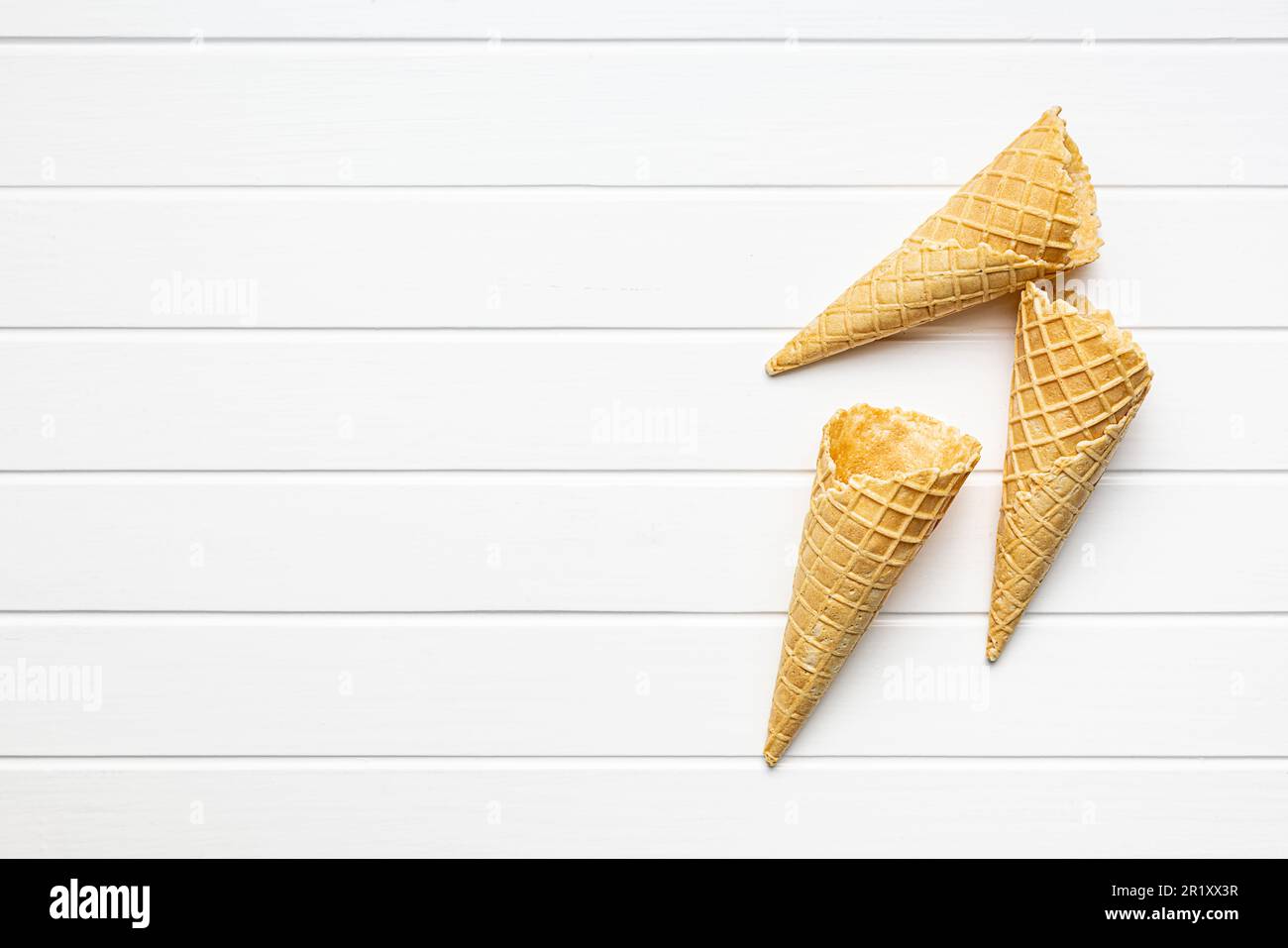 Empty wafer cone. Sweet ice cream cornet on the kitchen table. Top view ...