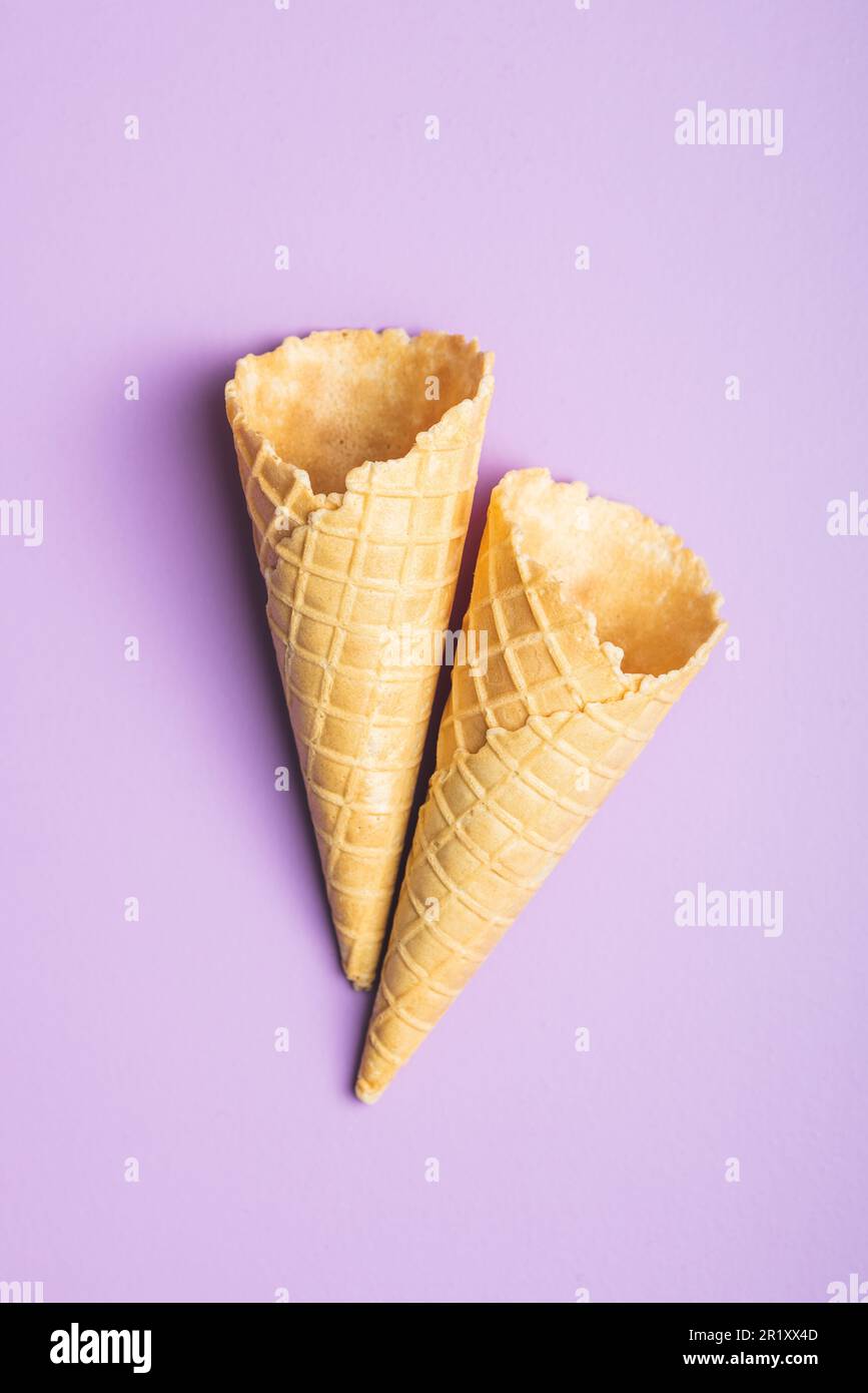 Empty wafer cone. Sweet ice cream cornet on the violet background. Top ...