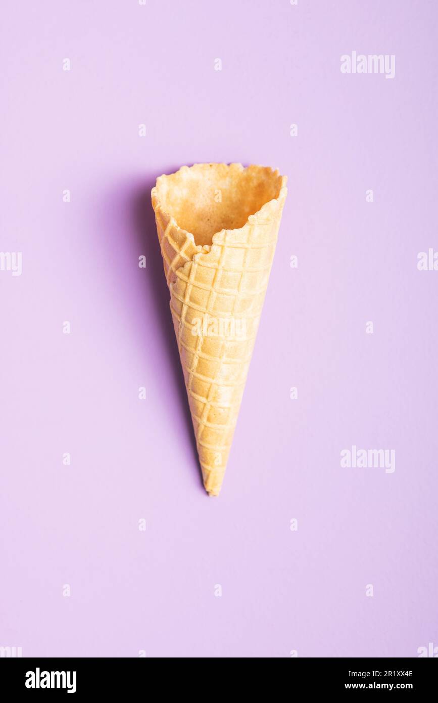 Empty wafer cone. Sweet ice cream cornet on the violet background. Top ...