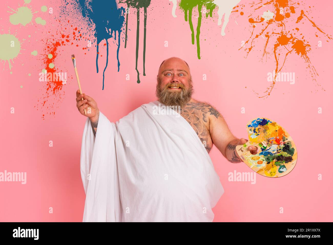 Fat man acts like an important artist with brush and color set in hand ...