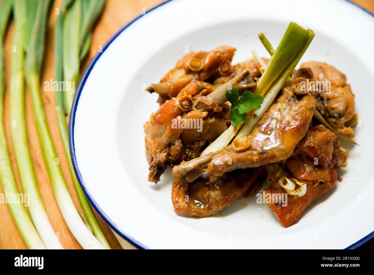 Fried rabbit cooked with lemon sauce and young garlic Stock Photo - Alamy